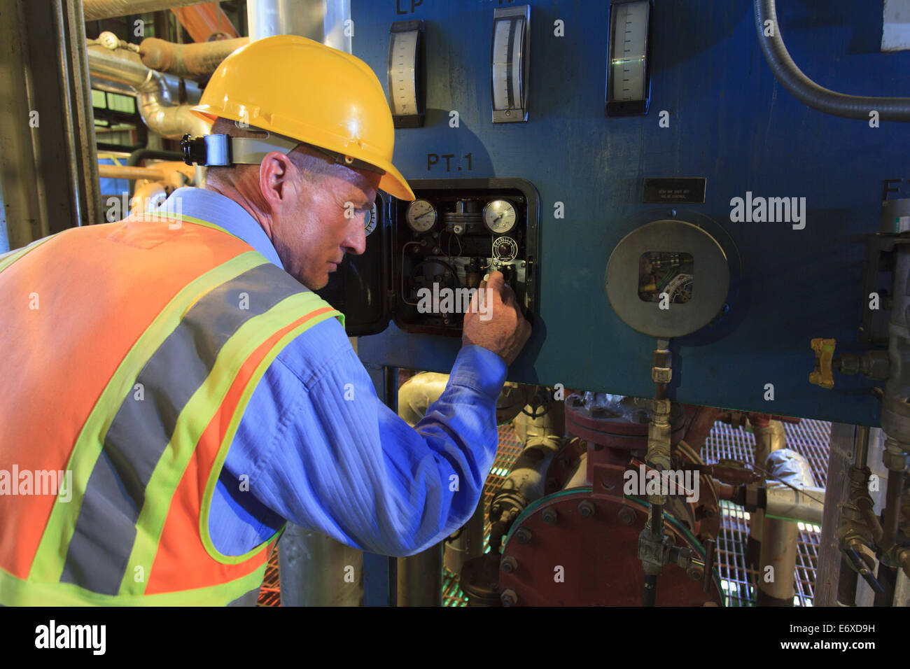 Engineer in electric power plant reviewing sensor readings Stock Photo ...