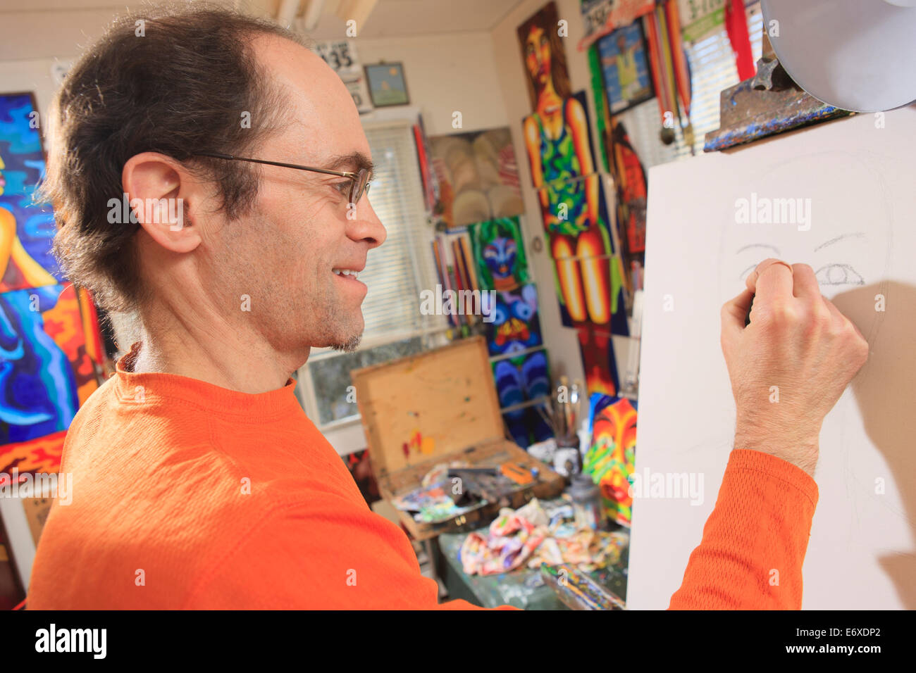 Man with Aspergers drawing his outline for his painting in his art ...