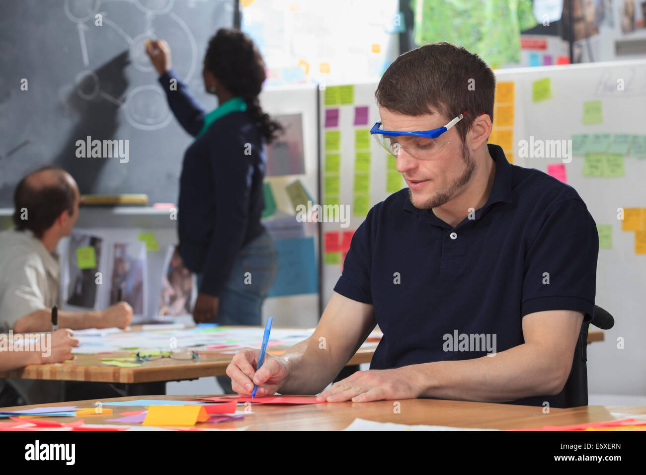 Engineering instructor working on flowchart on blackboard while ...