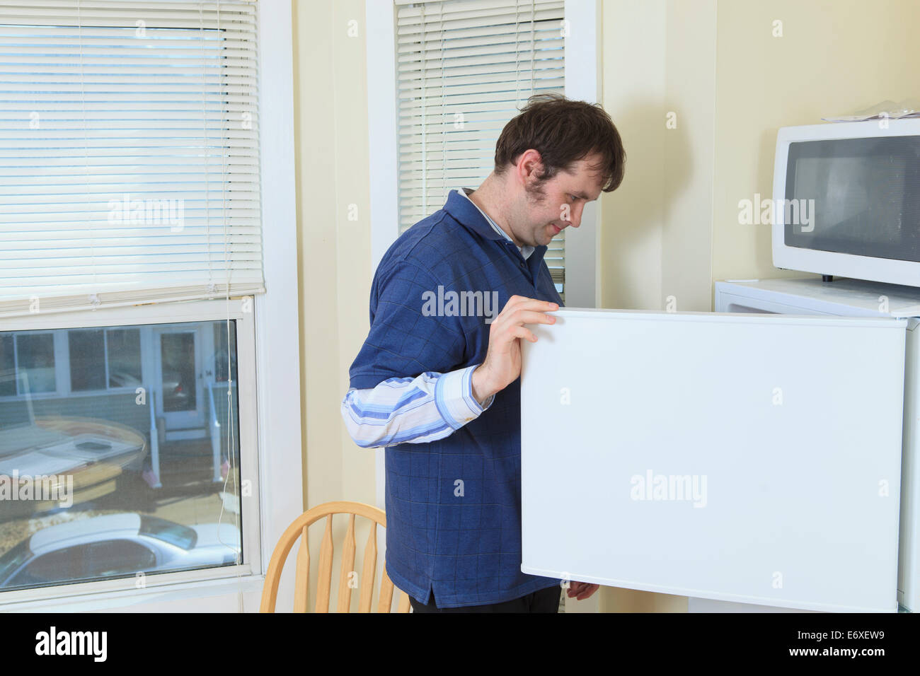 Man looking in refrigerator hi-res stock photography and images - Alamy