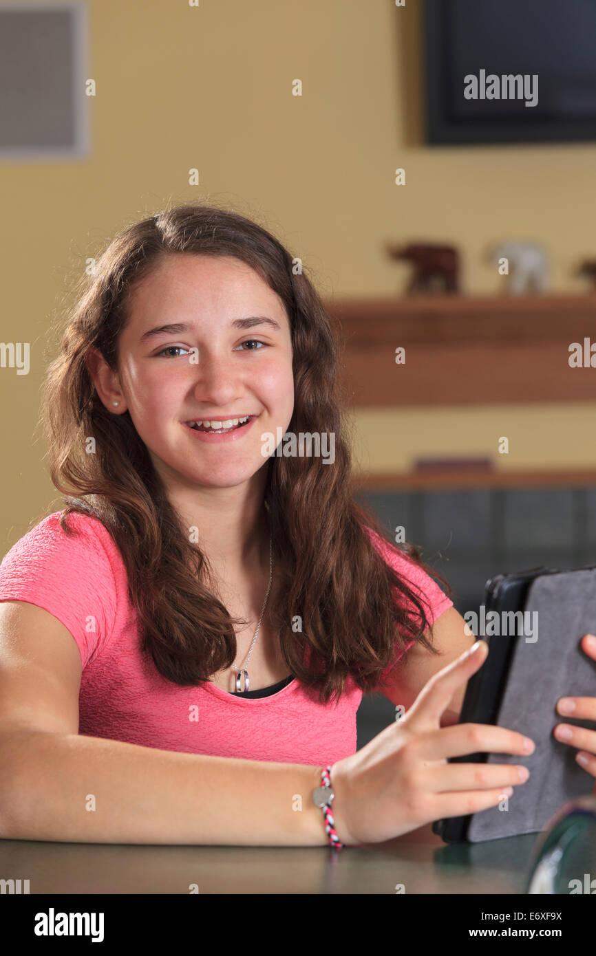 Happy teen girl using digital hi-res stock photography and images - Alamy