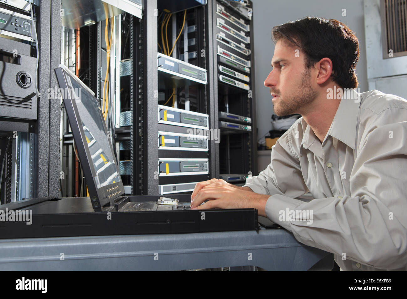 Network engineer in cable server room programming configurations Stock ...