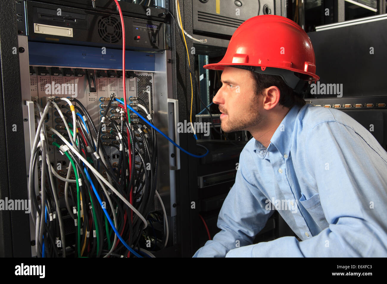 Network engineer examining system configuration at patch panel Stock ...