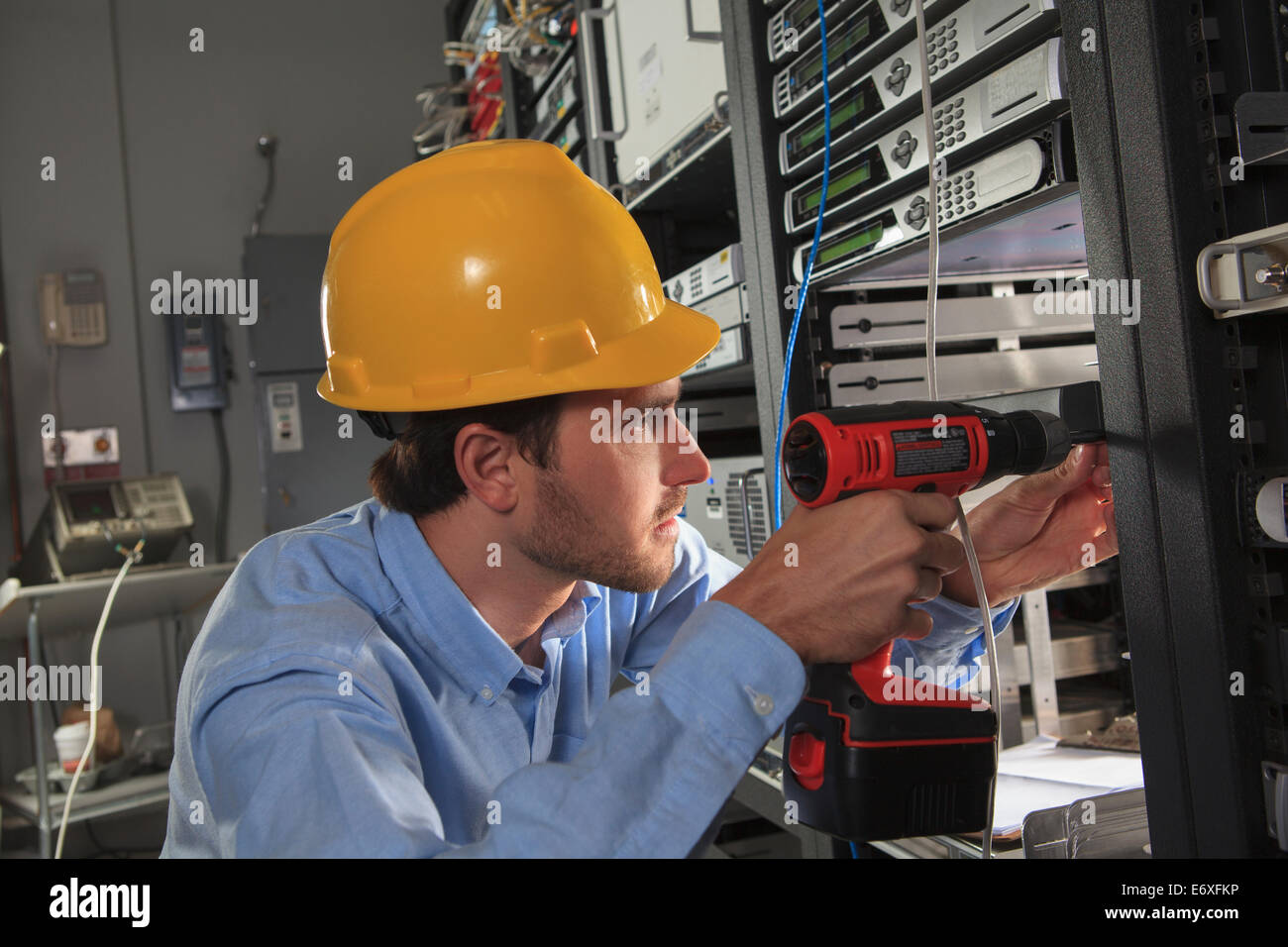 Network engineer installing cable equipment in rack Stock Photo - Alamy