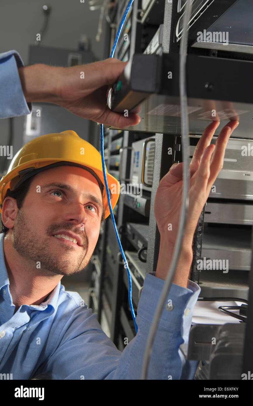 Engineer connecting network cable switch hi-res stock photography and ...