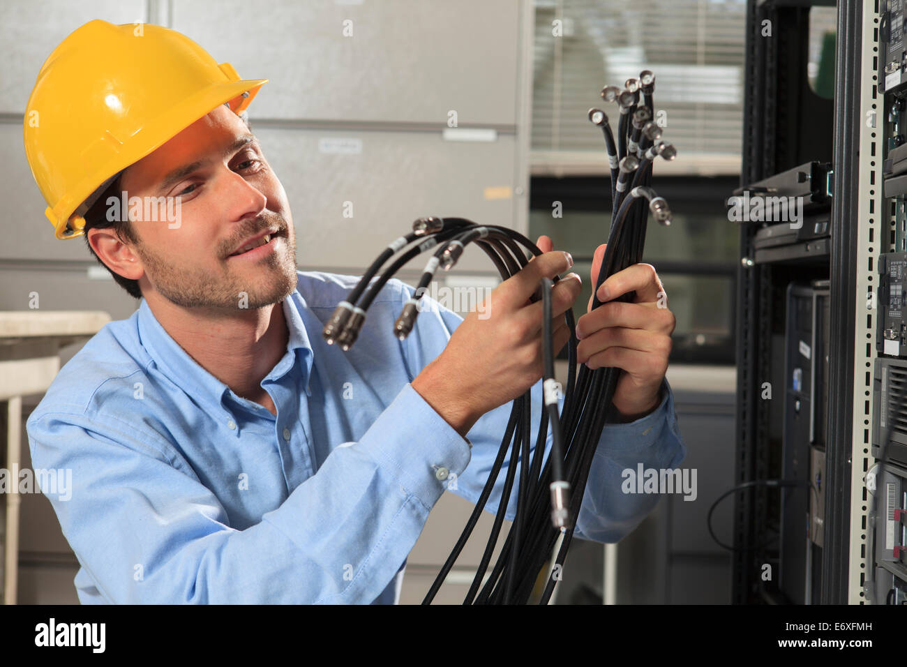 Network engineer preparing structured cabling for data center Stock ...