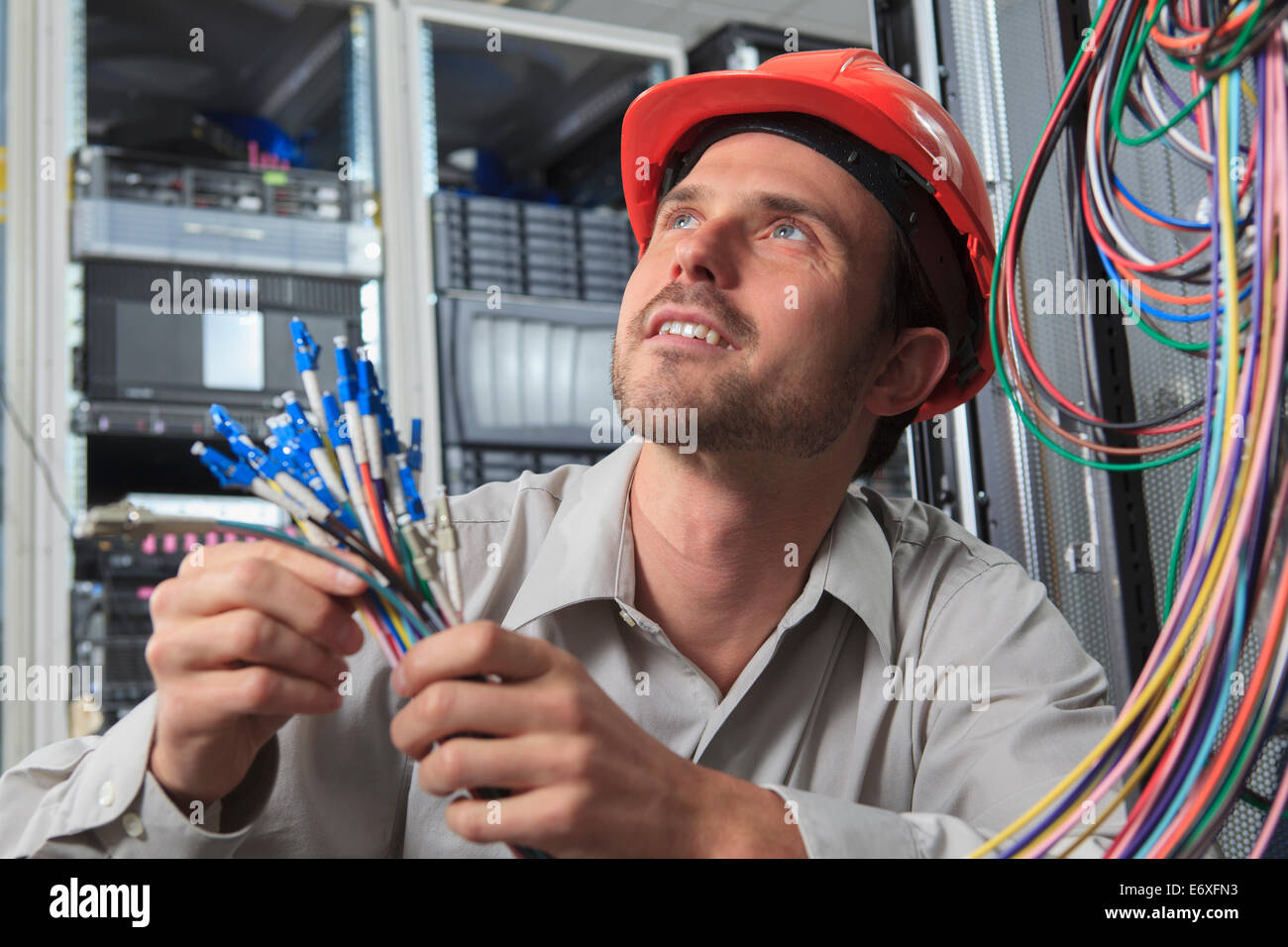 Network engineer preparing fiber cables in data center Stock Photo - Alamy