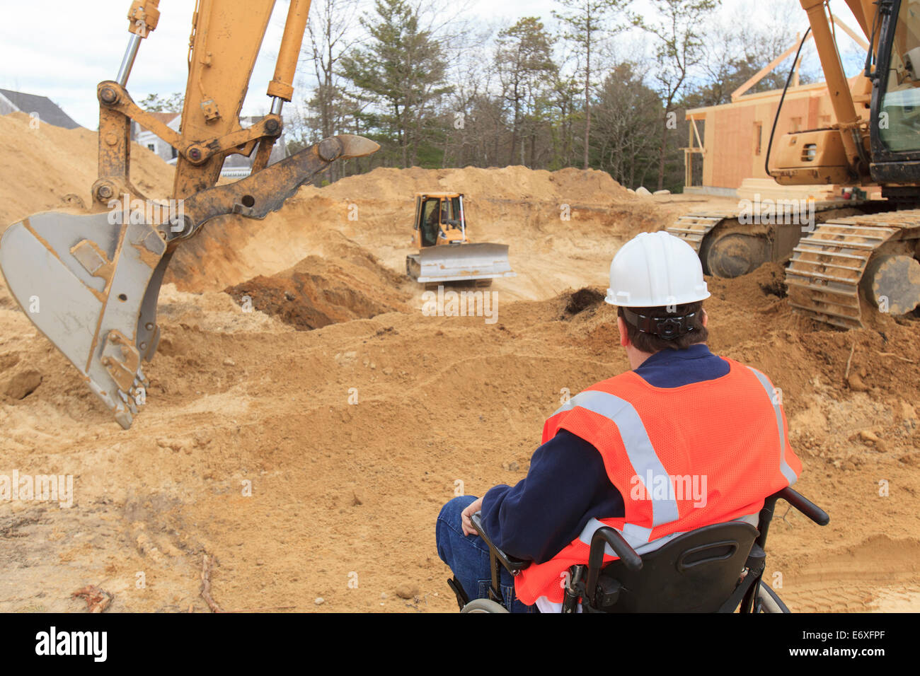 Construction engineer with spinal cord injury inspecting new foundation ...