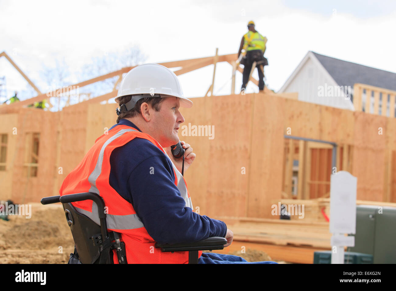 Construction engineer with spinal cord injury talking on radio at home ...