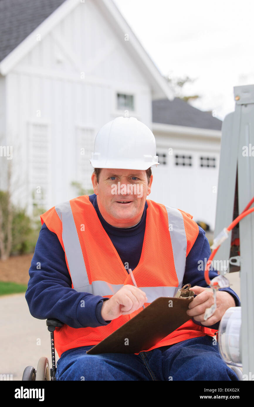 Construction engineer with spinal cord injury taking notes at temporary ...