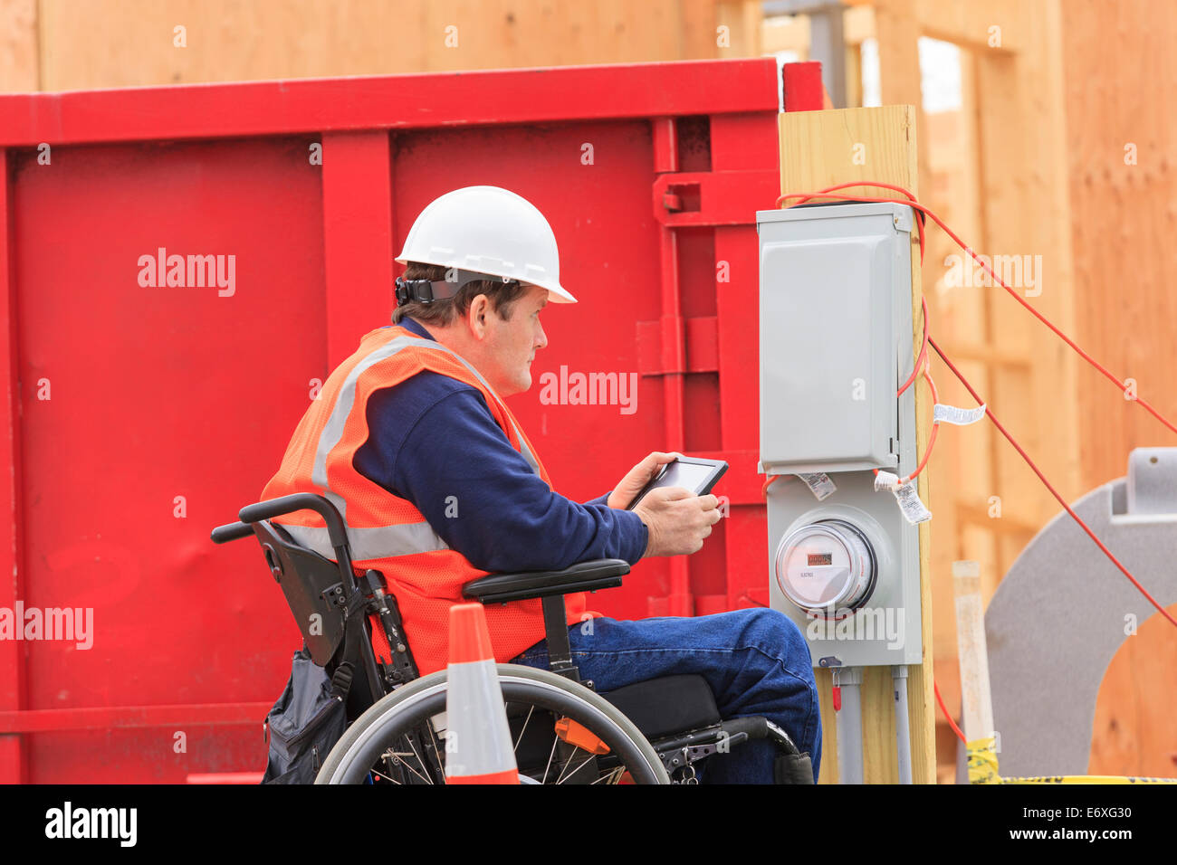 Construction engineer with spinal cord injury using tablet to take ...