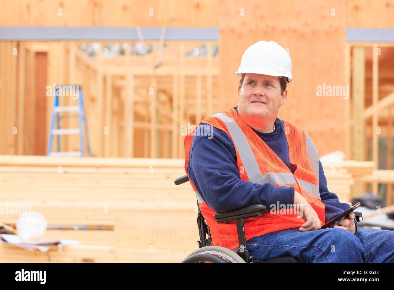 Construction engineer with spinal cord injury using tablet to take ...