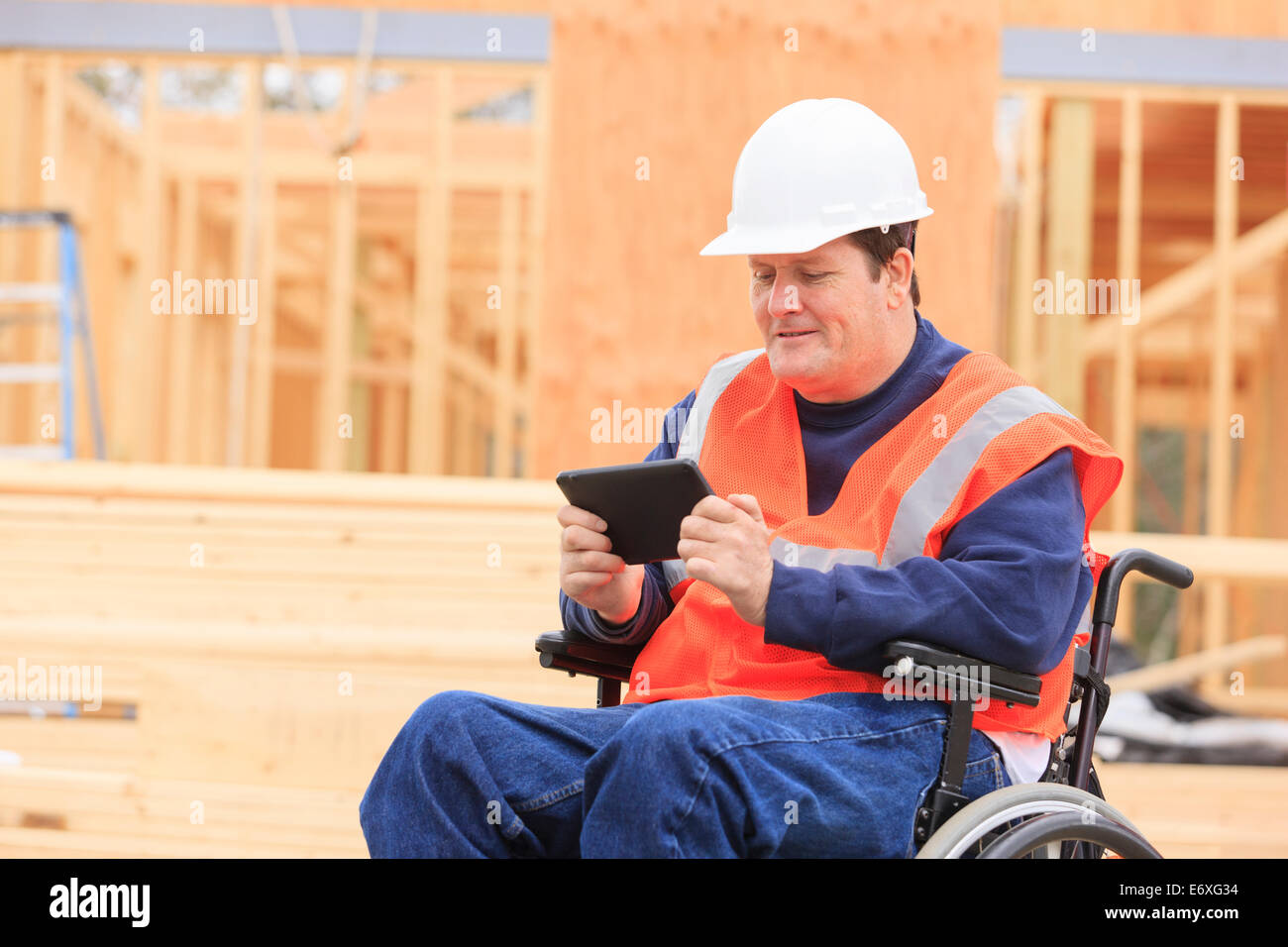 Construction engineer with spinal cord injury using tablet to take ...