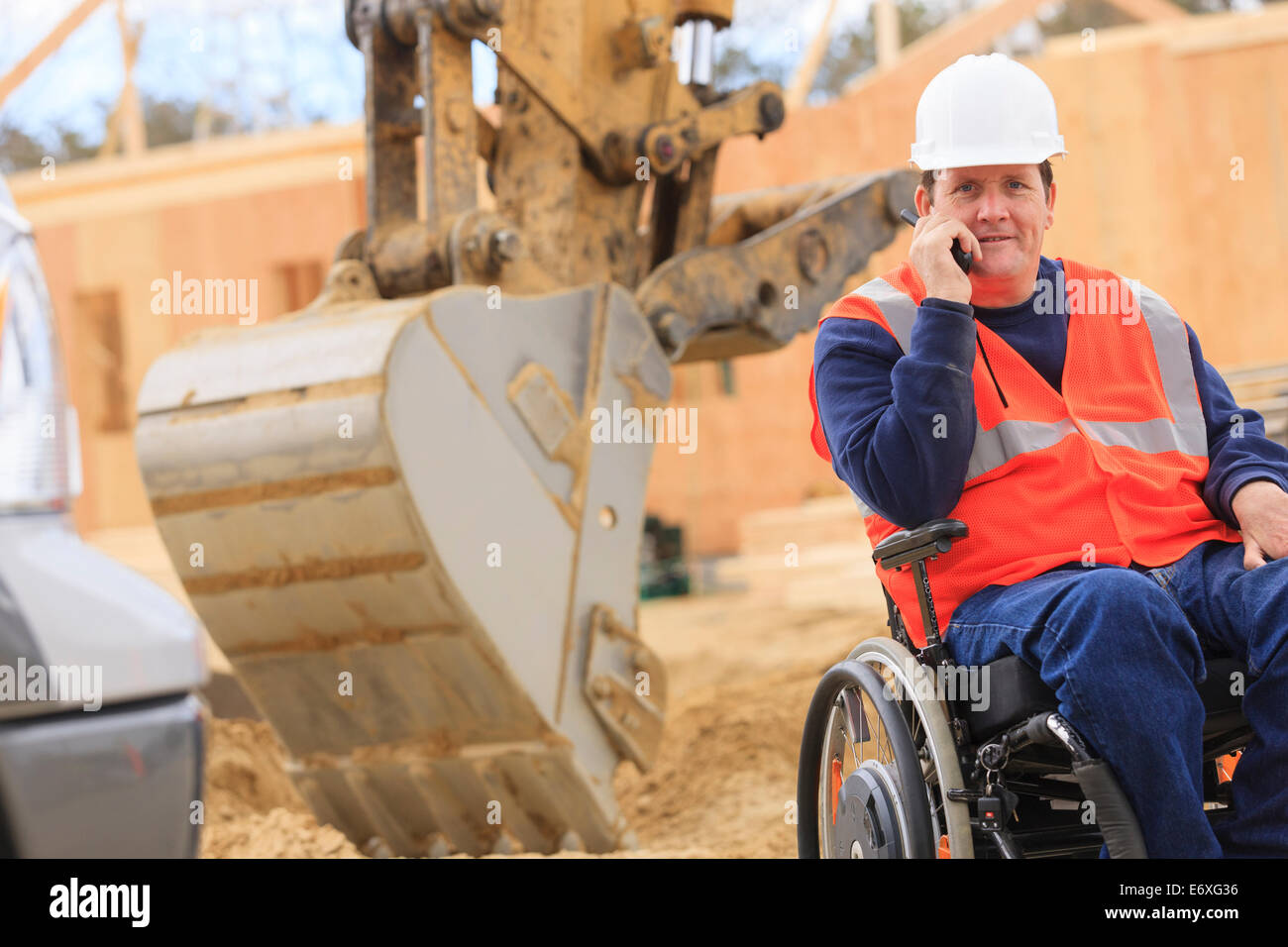 Construction engineer with spinal cord injury on radio to equipment ...