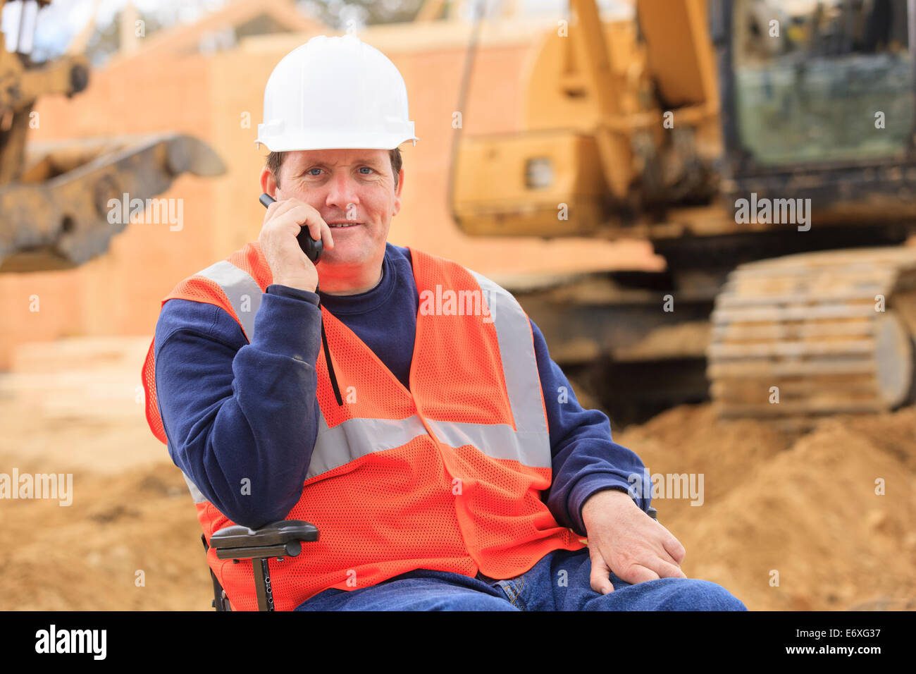 Construction engineer with spinal cord injury on radio to equipment ...