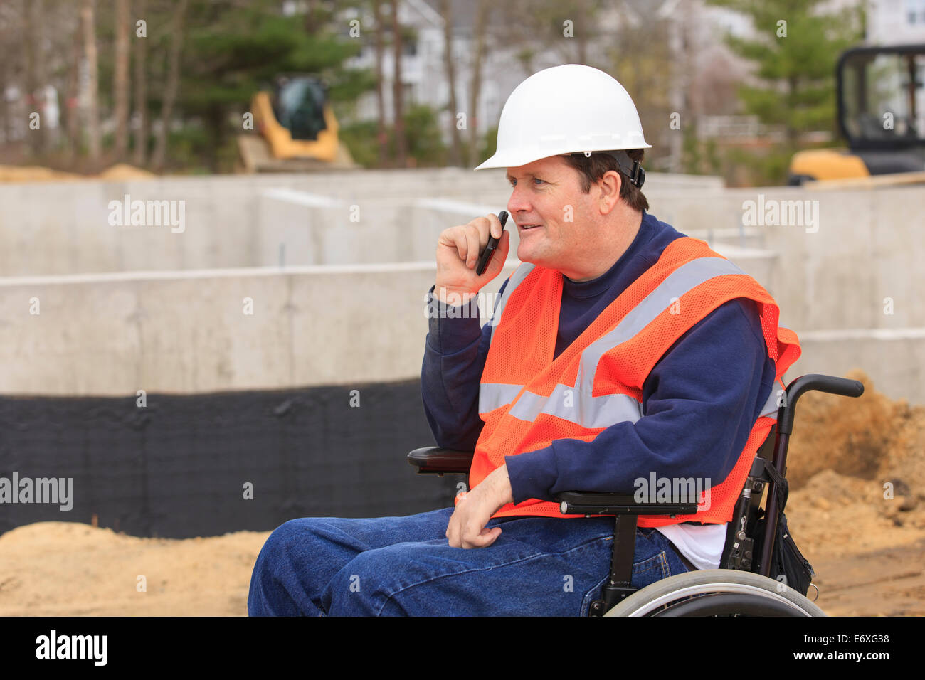 Construction engineer with spinal cord injury on radio at foundation ...