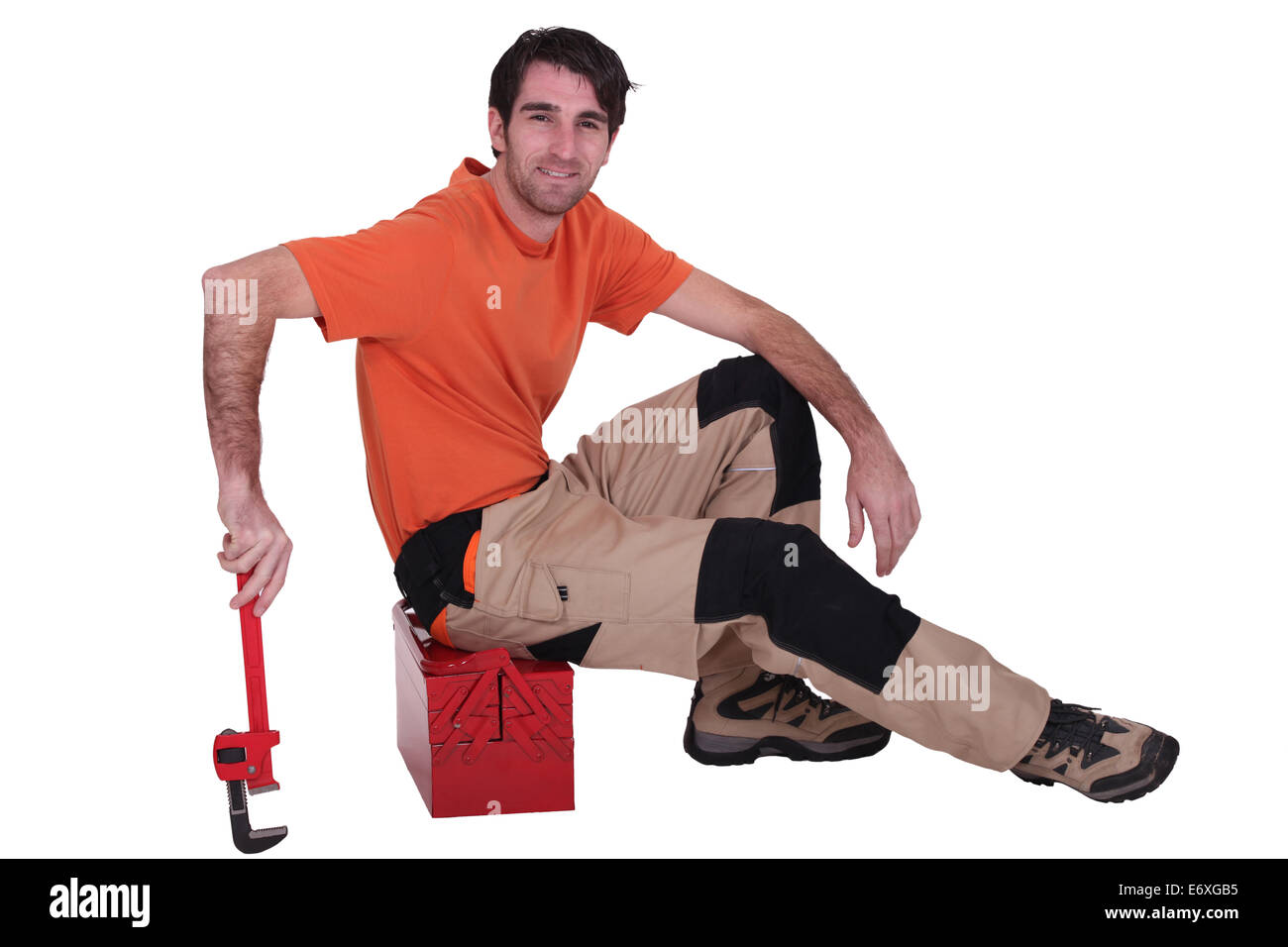 Man sitting on toolbox Stock Photo - Alamy
