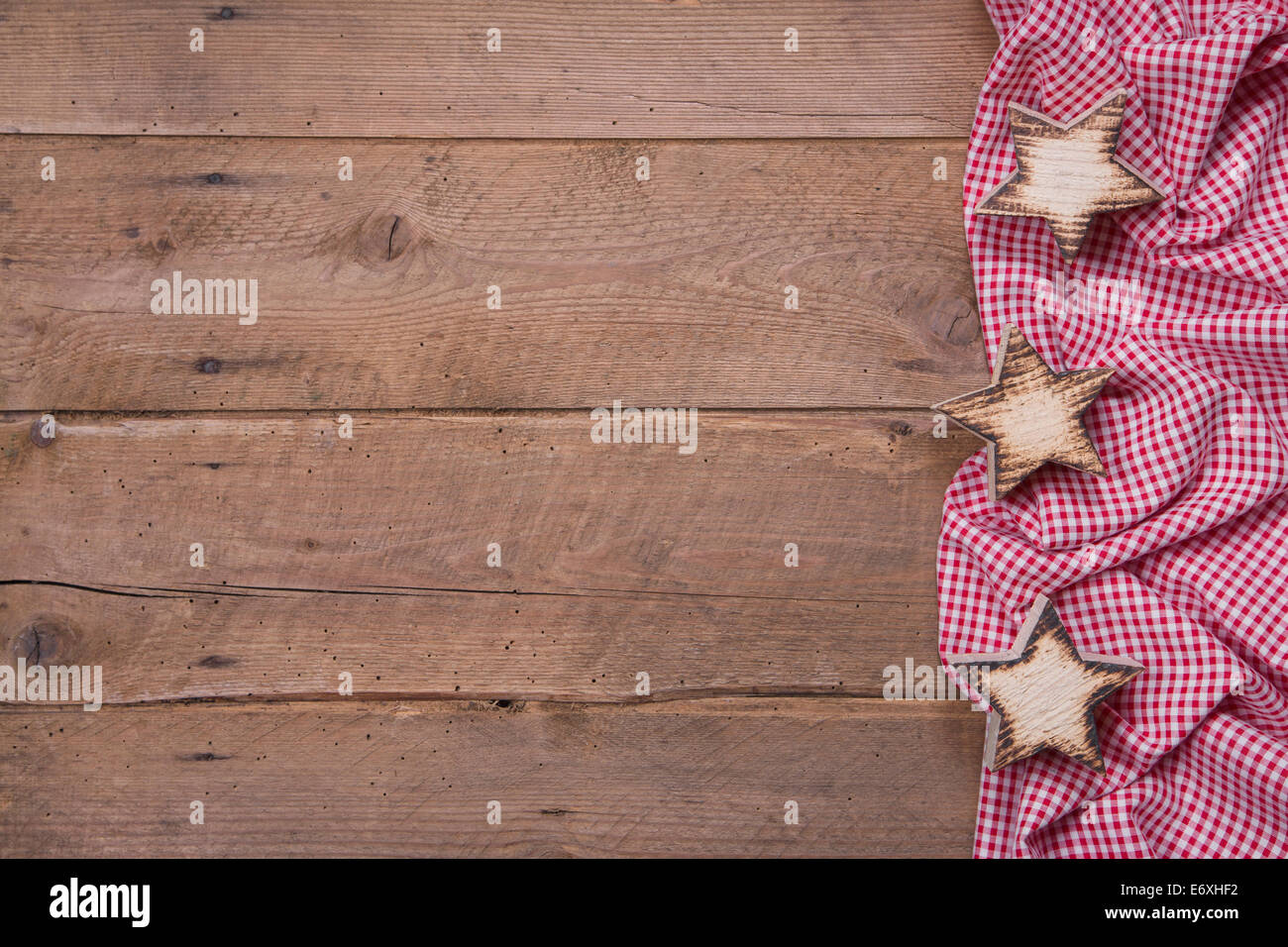 Wooden background with stars and a red checkered frame for Christmas or ...