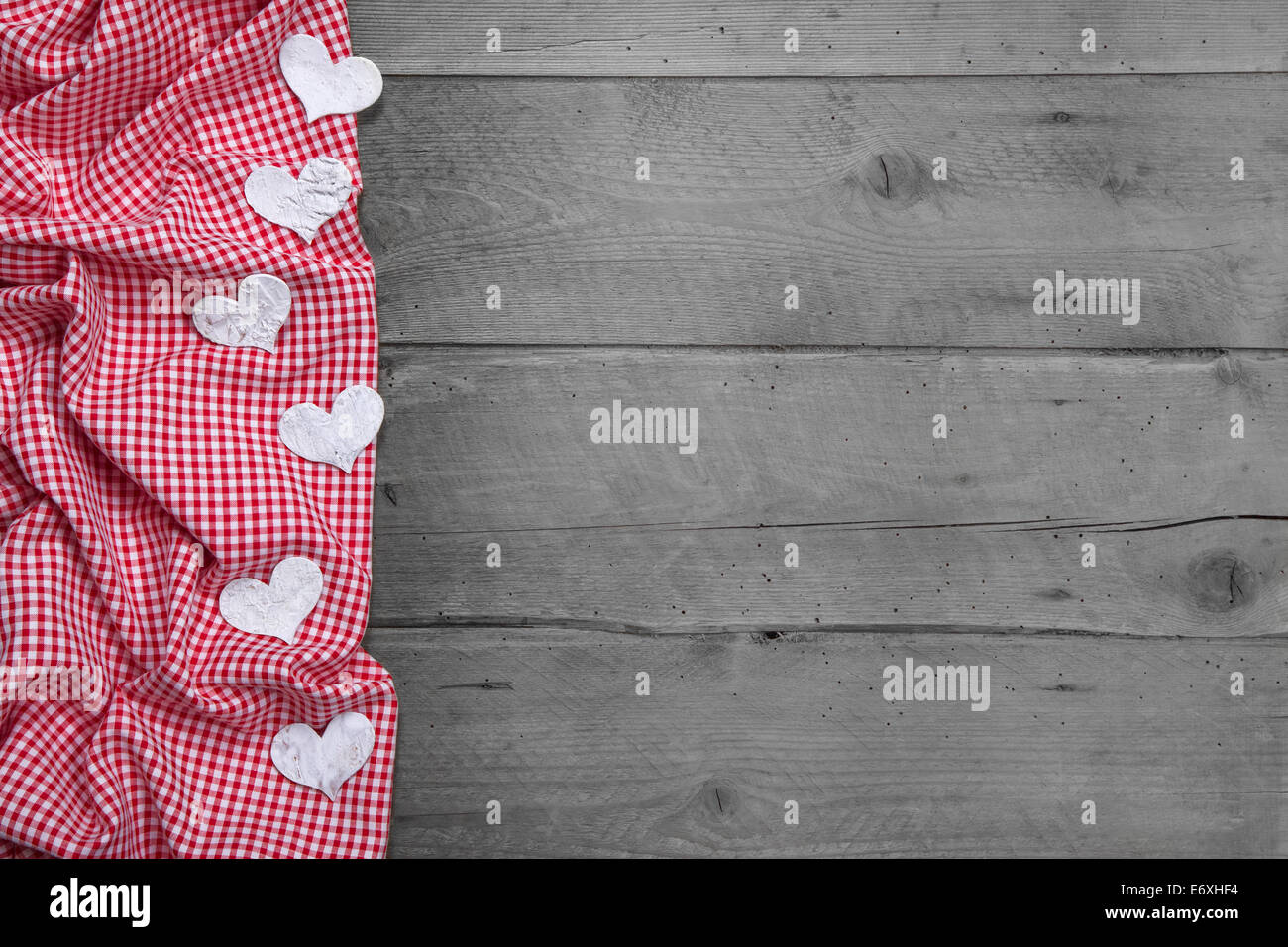 Red and white checkered frame with hearts on rustic wooden background ...