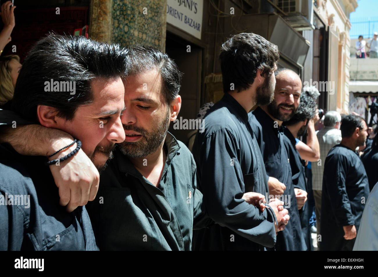 Christian monks holding hands protect priests from flow of people ...