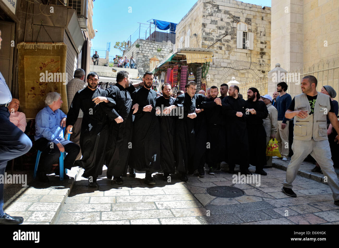 Christian monks holding hands protect priests from flow of people ...