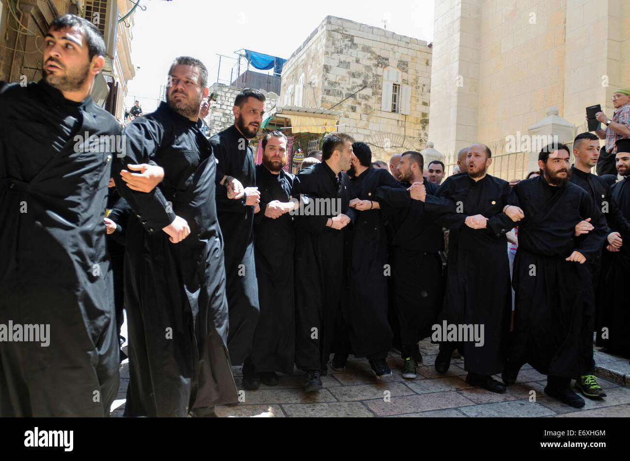 Christian monks holding hands protect priests from flow of people ...