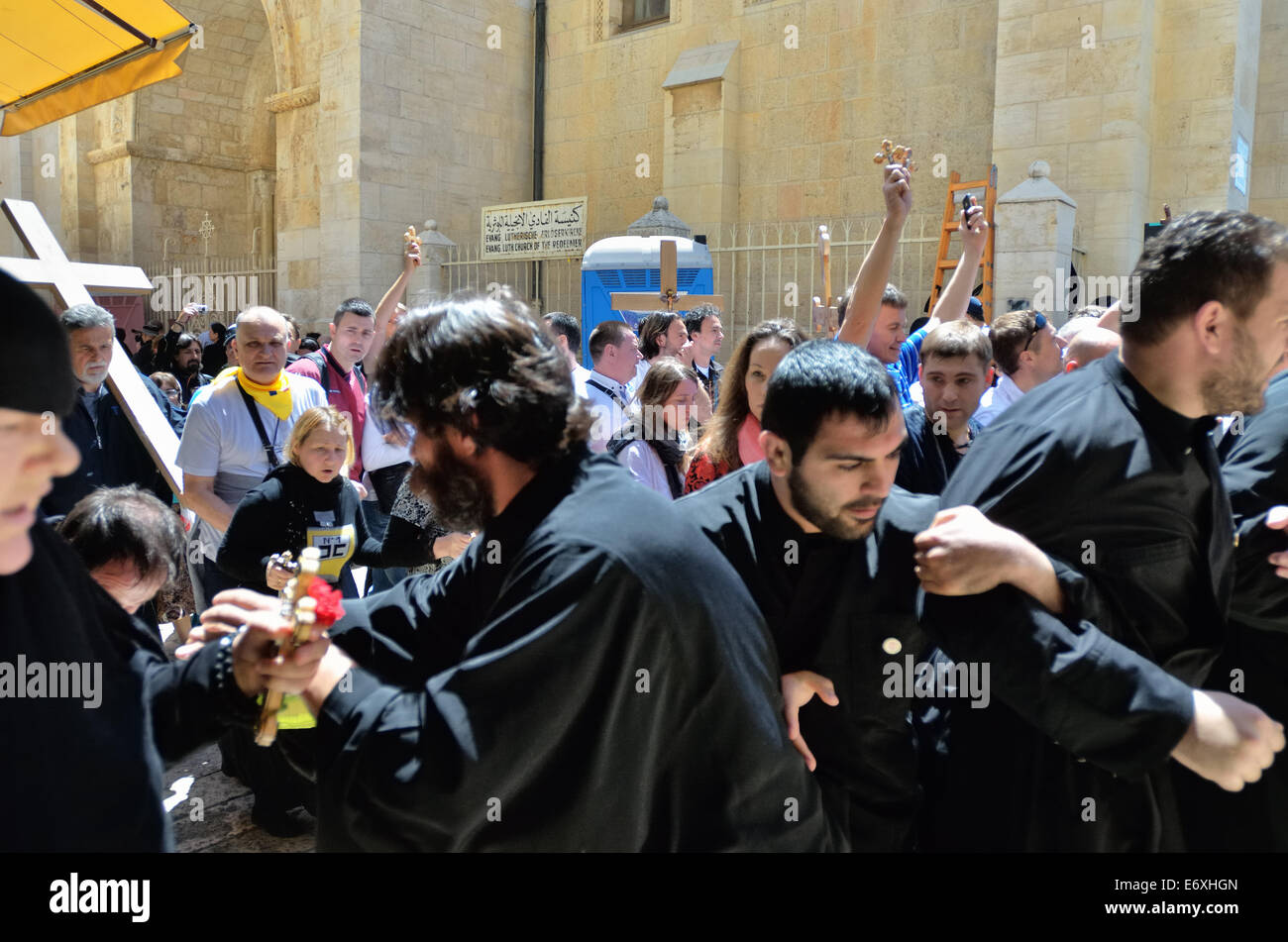 Christian monks holding hands protect priests from flow of people ...