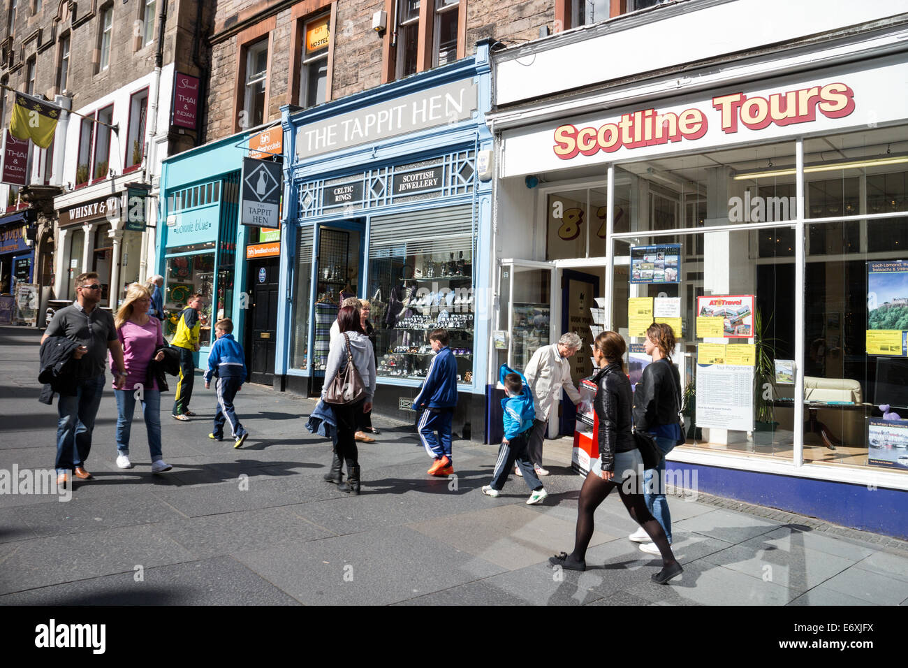 Shoppers and tourists walking past shops on the Royal Mile, Edinburgh ...