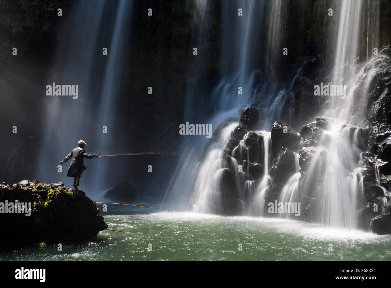 Fisherman at Lily waterfall near the village of Ampefy, Madagascar ...