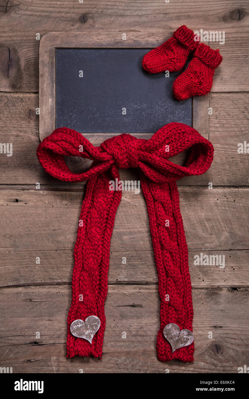 Chalk board with red knitted sock and bow on wooden background for ...