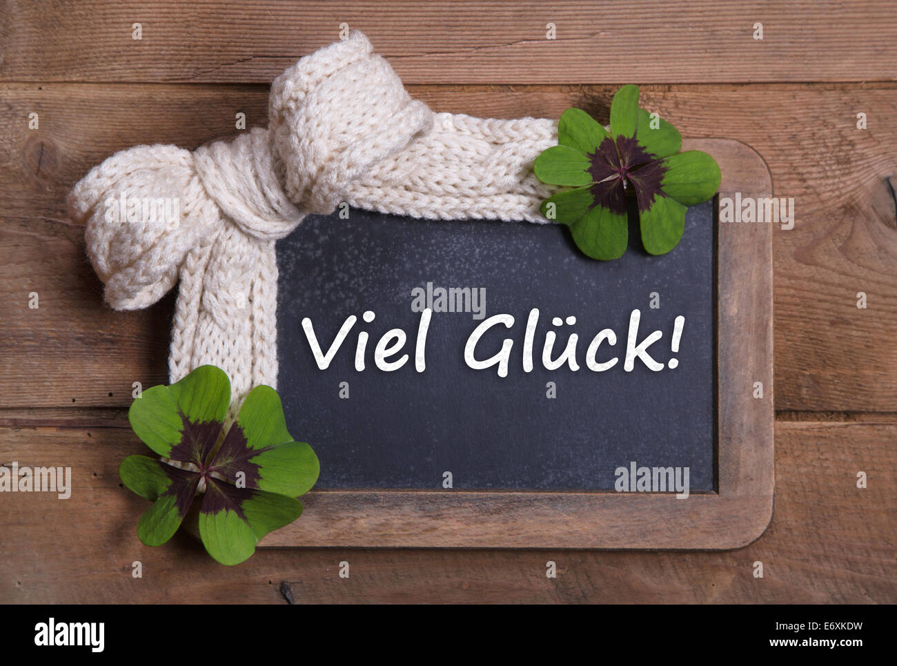 Menu board with good luck message in german - clovers and white bow on ...