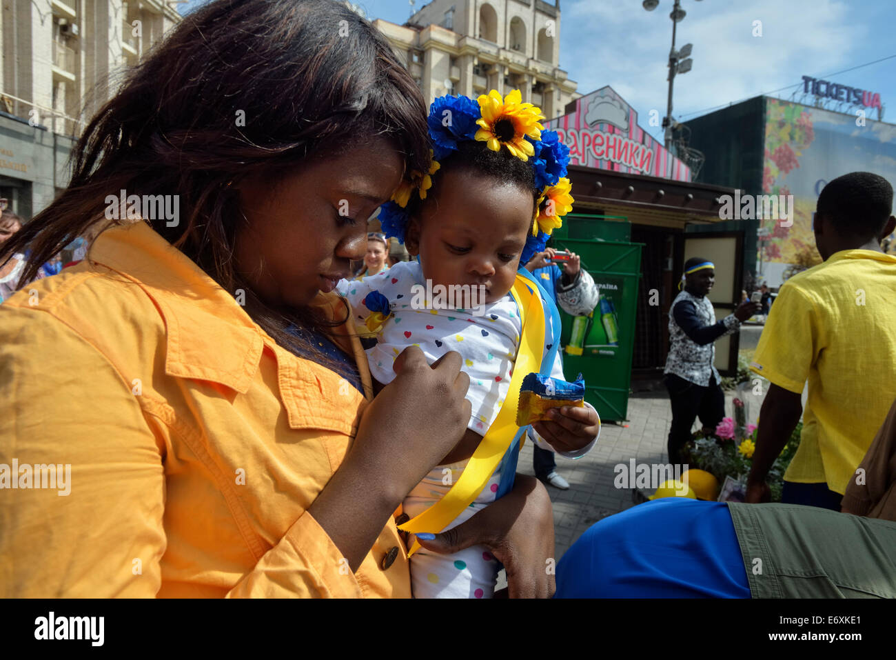 African child, wearing wreath in colors of Ukrainian national flag ...
