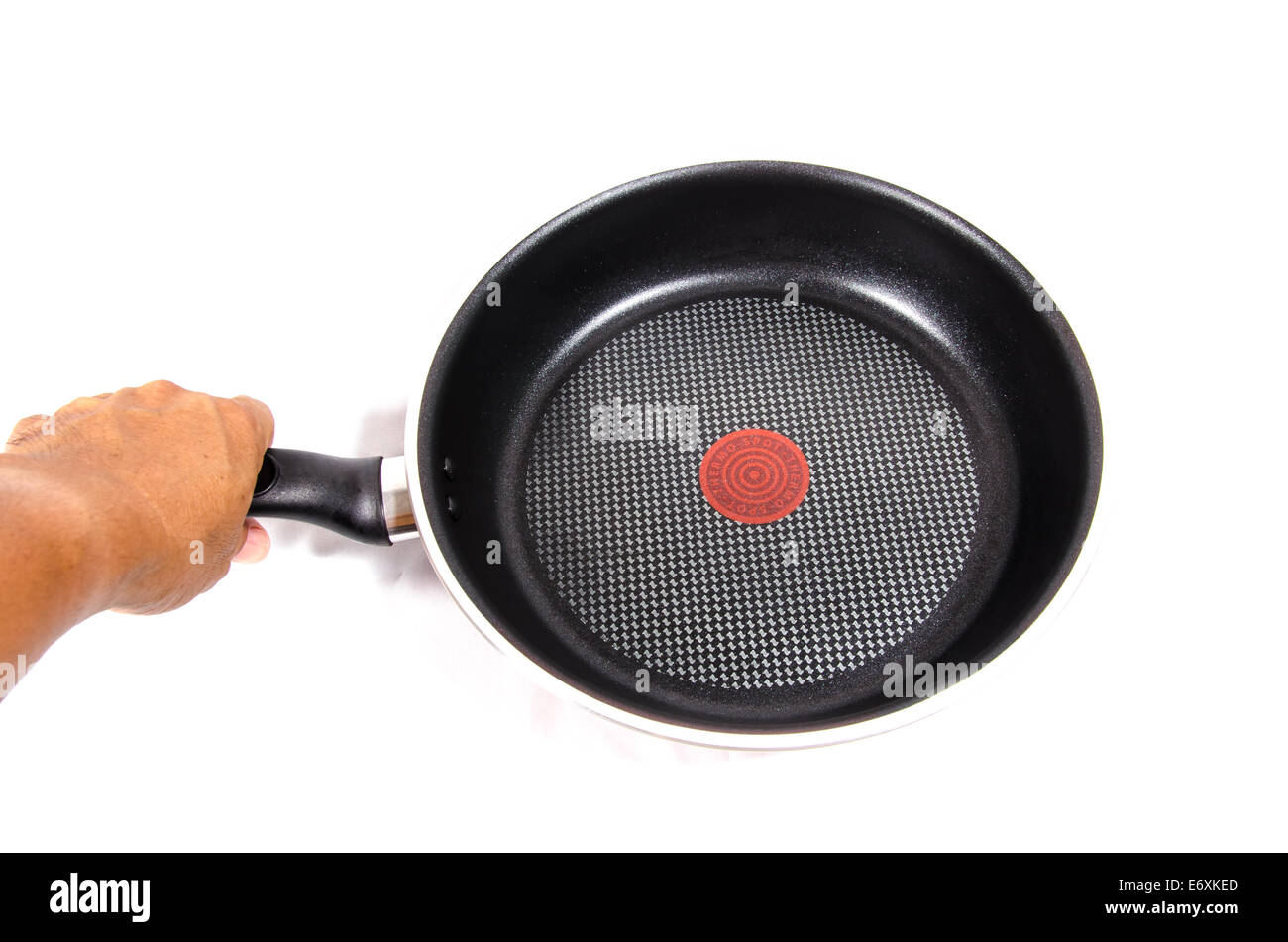 hand for cook with black pan on white background Stock Photo - Alamy