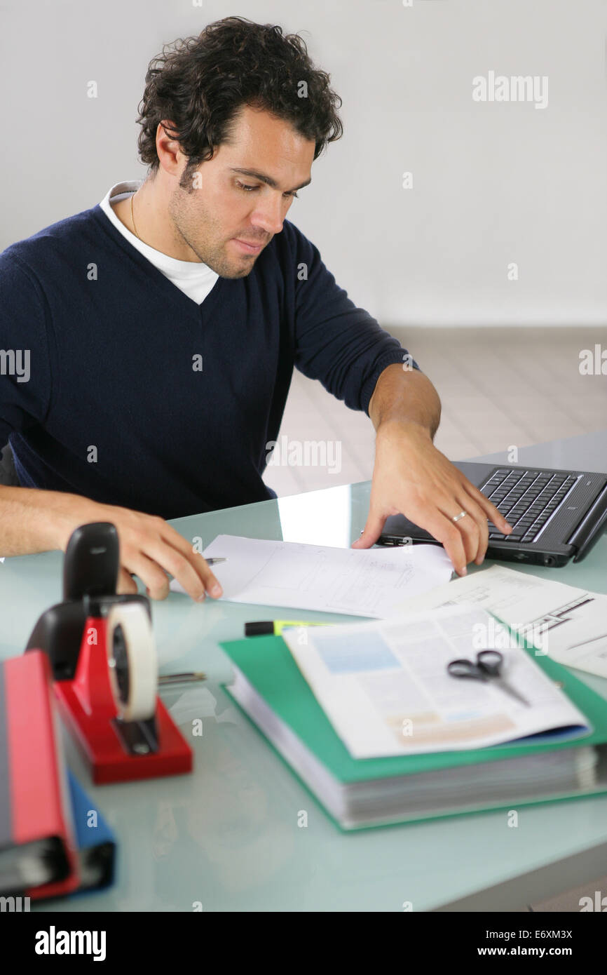 Man working at a desk Stock Photo - Alamy