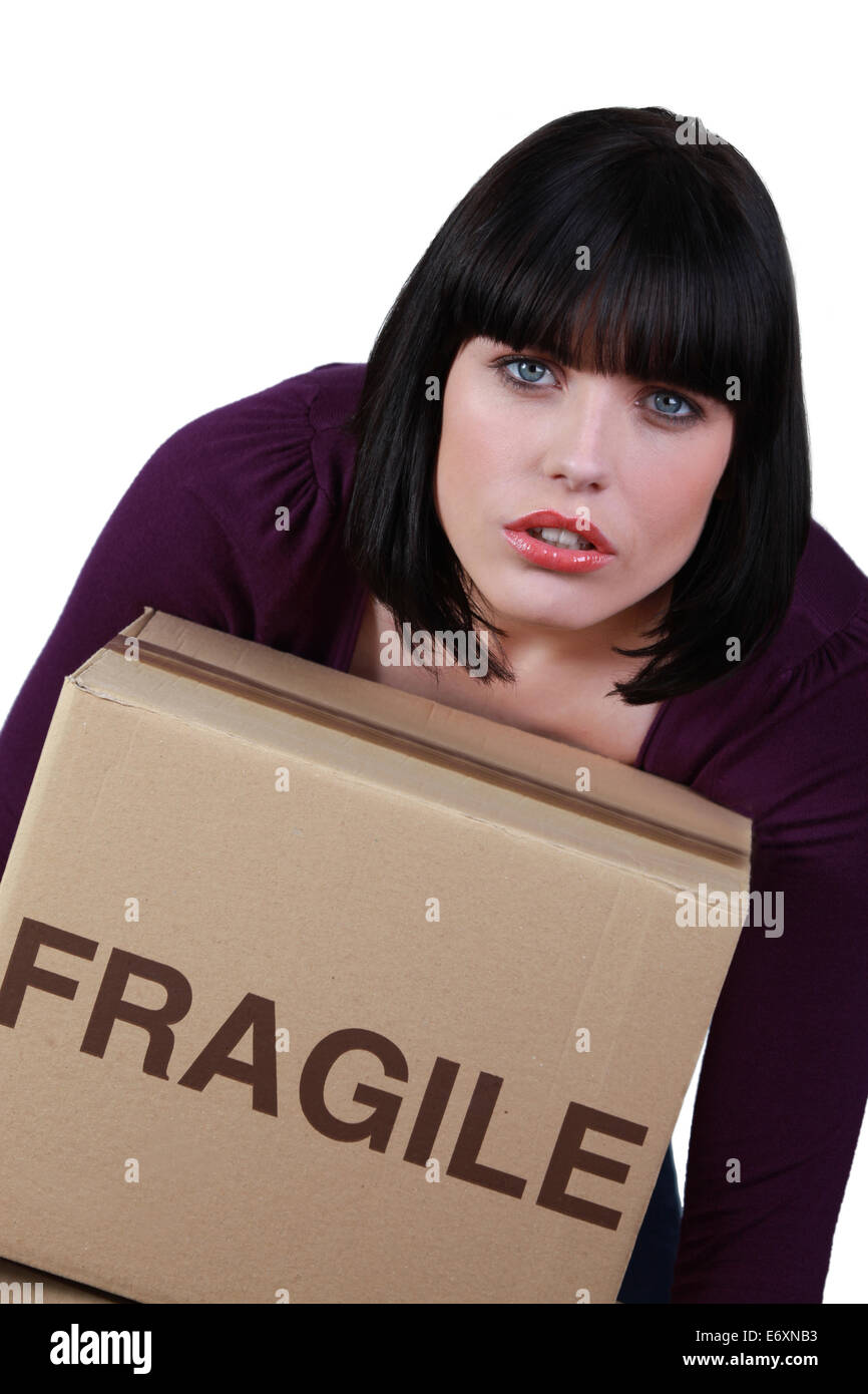 Woman carrying a heavy box Stock Photo - Alamy