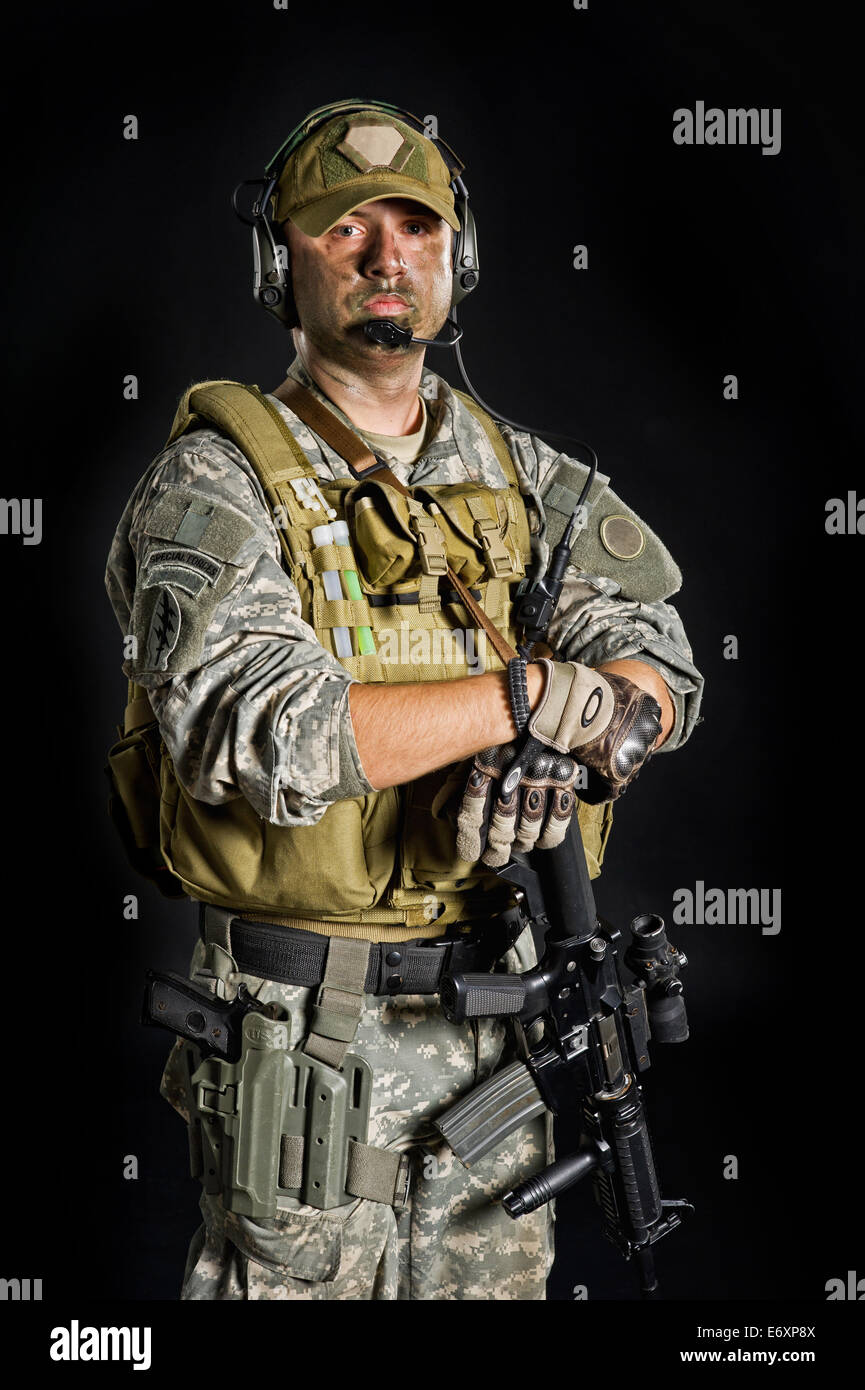 Soldier of USA army posing with a gun on a black background Stock Photo ...