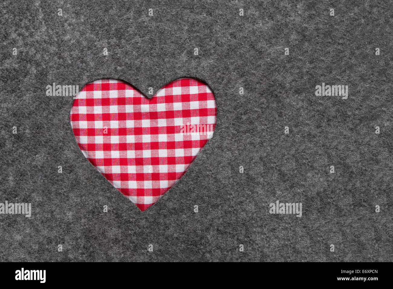 Red and white checkered heart on grey felt background for christmas ...