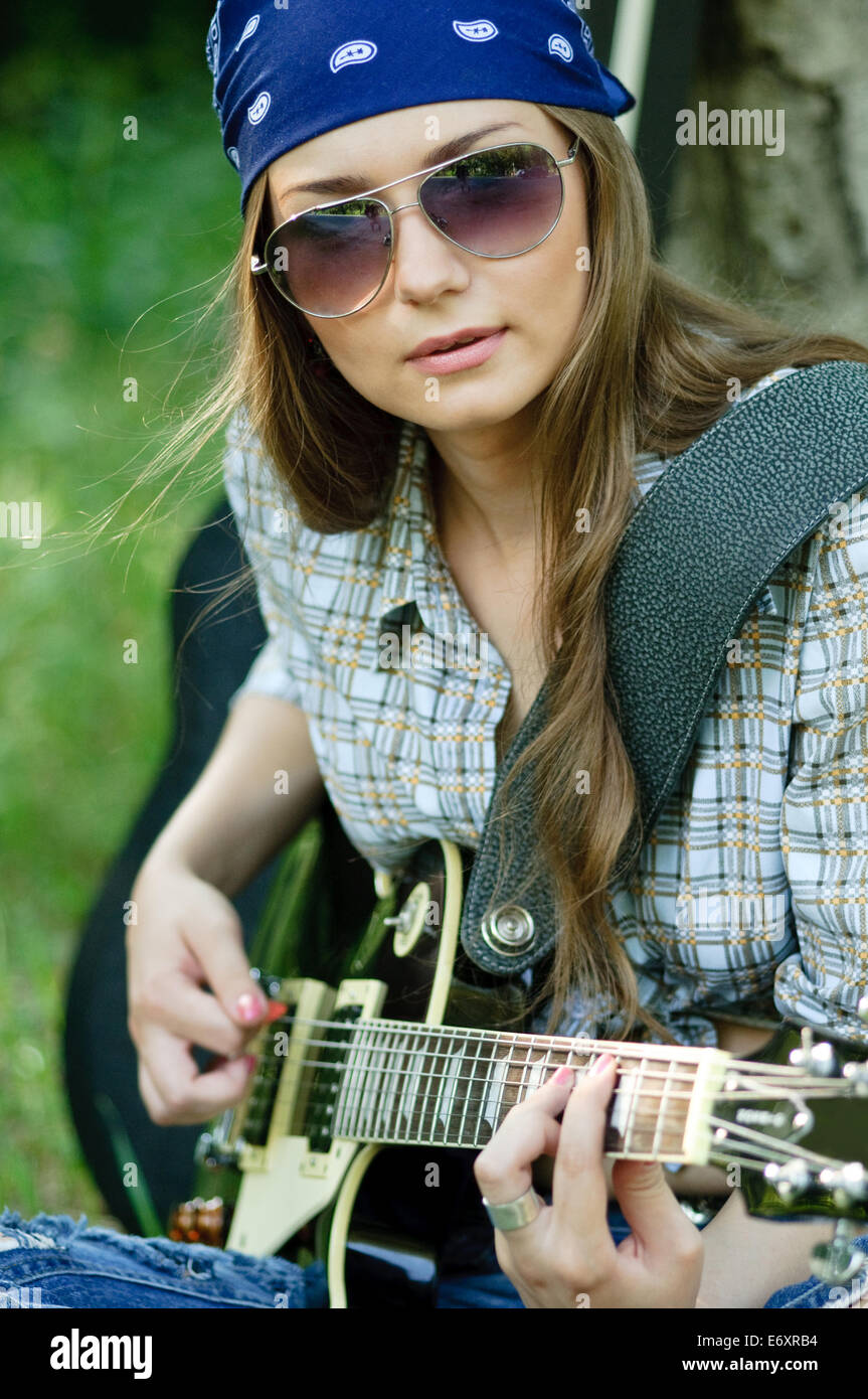 Rocking girl on a nature with guitar Stock Photo - Alamy