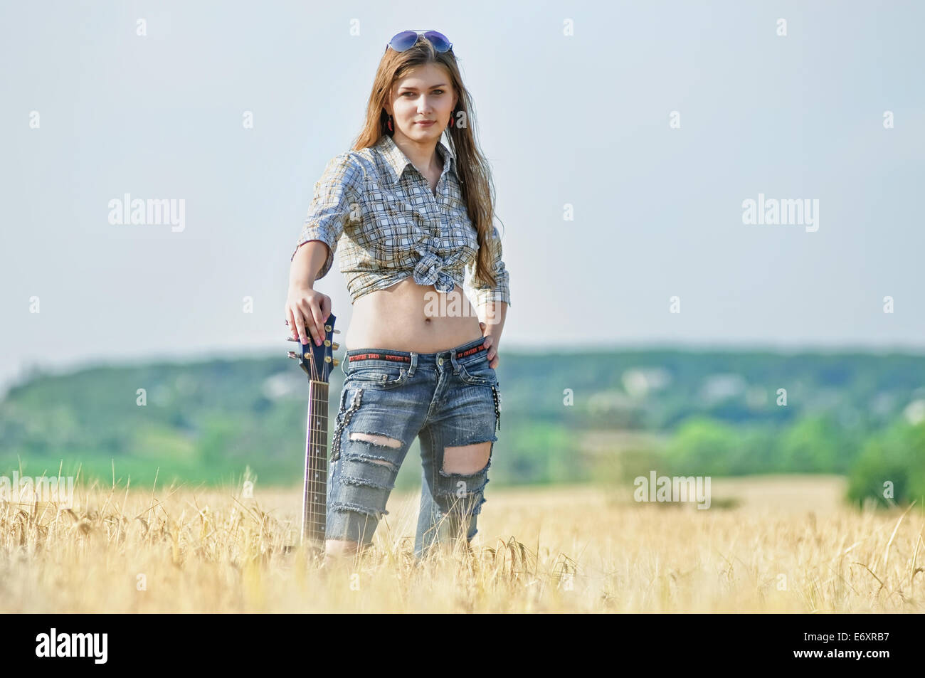 Rocking girl on a nature with guitar Stock Photo - Alamy