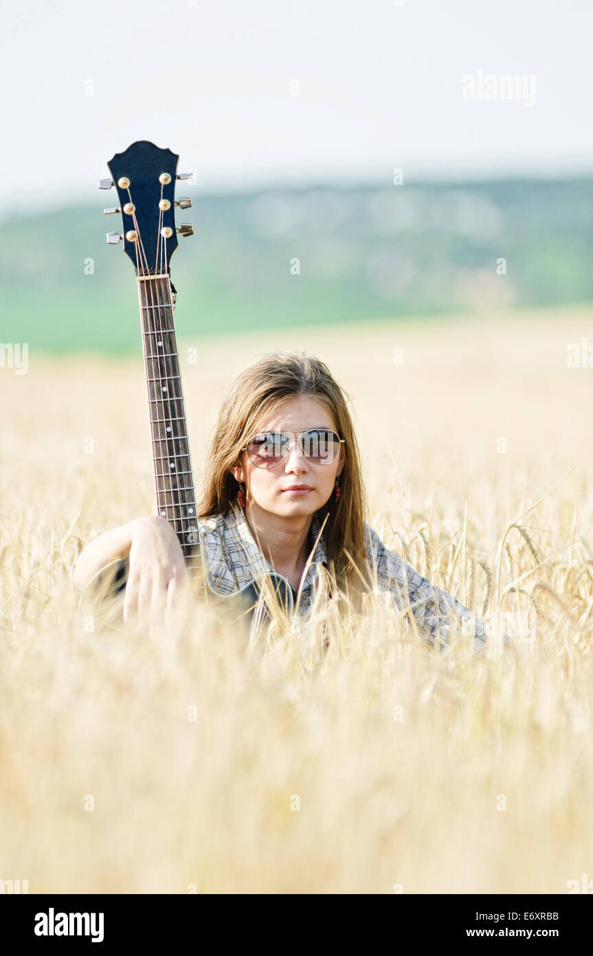 Rocking girl on a nature with guitar Stock Photo - Alamy