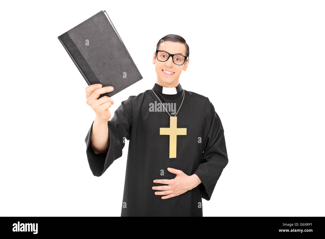 Happy young priest holding a holy bible isolated on white background ...