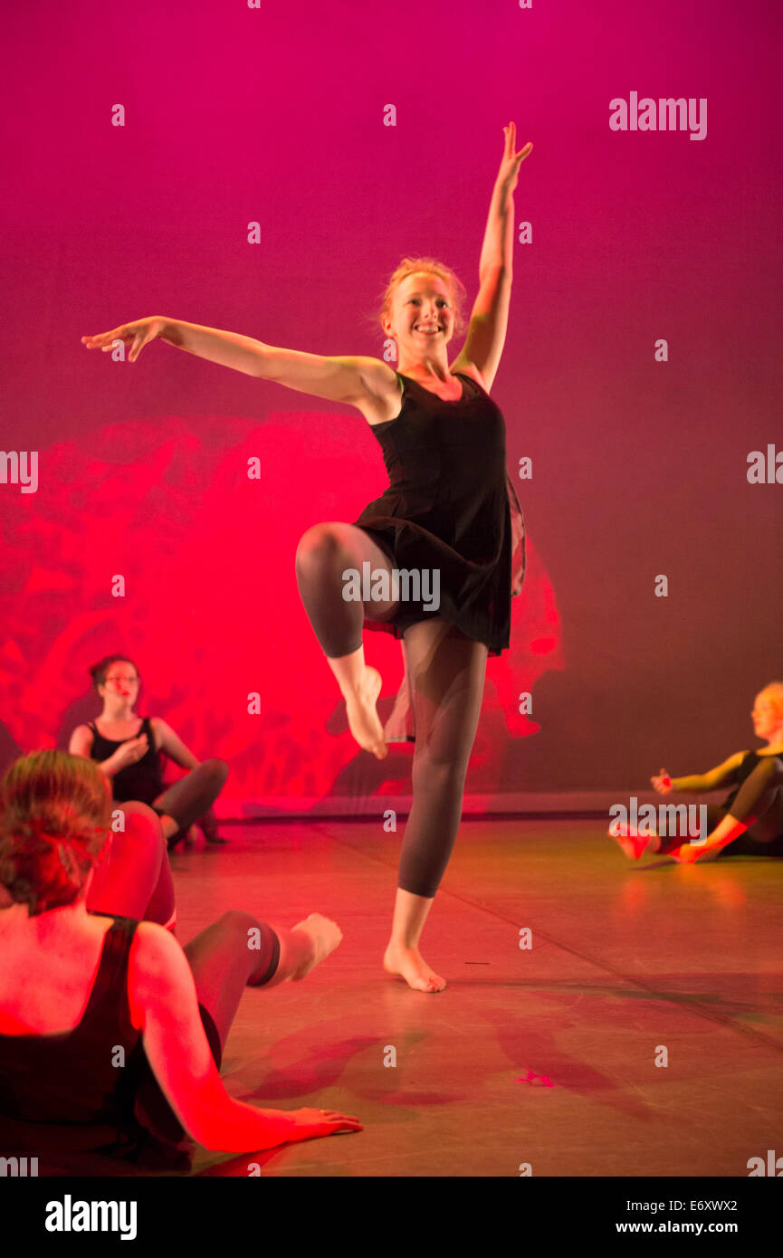 Teenage girls dancing on stage in a dance school showcase performance ...