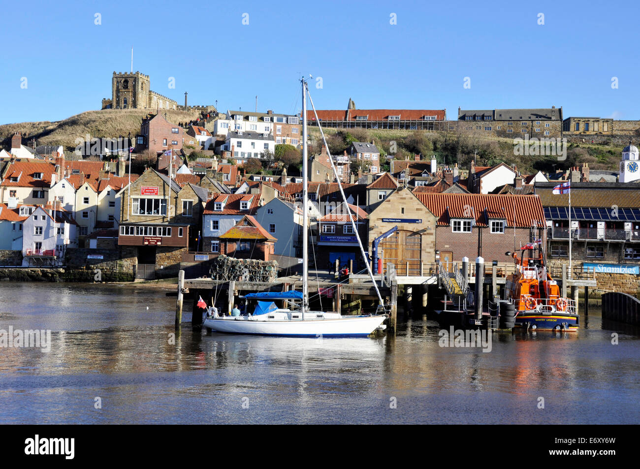 Postcard view of Whitby showing houses and Church on cliff top Stock ...
