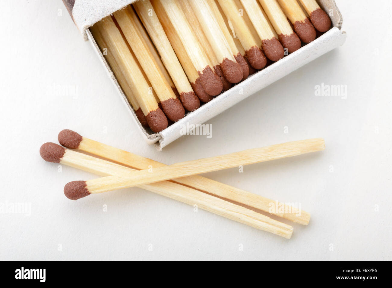 Matches in a cardboard matchbox on white paper background Stock Photo ...