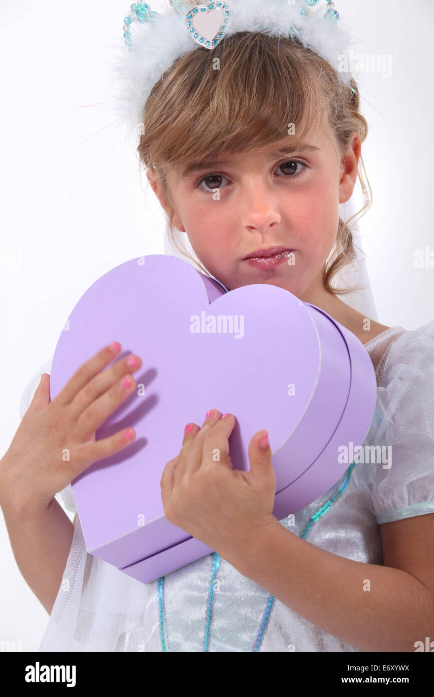 Little girl dressed as princess holding present Stock Photo - Alamy