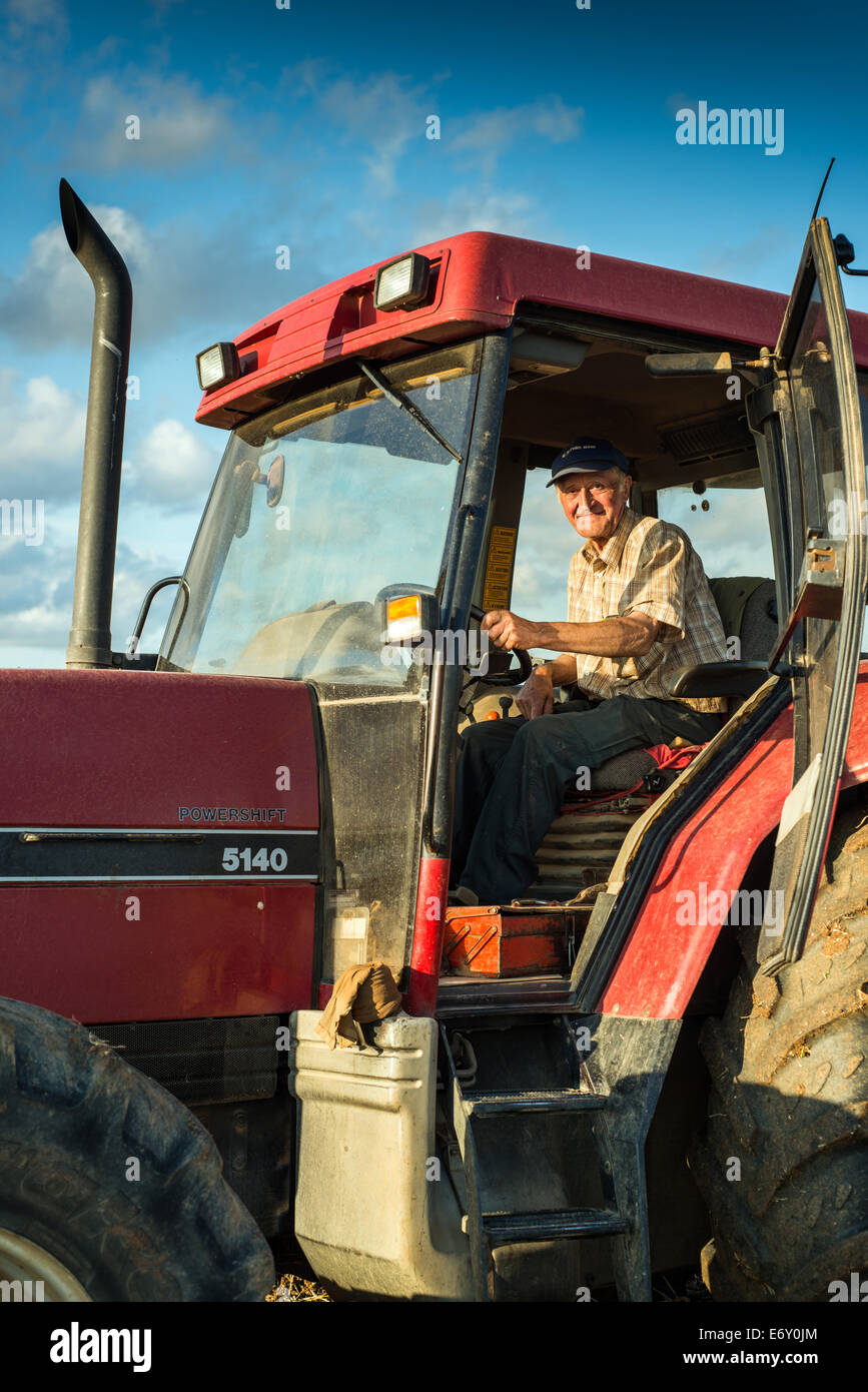 Man driving tractor in field west of Poitiers in south western France ...