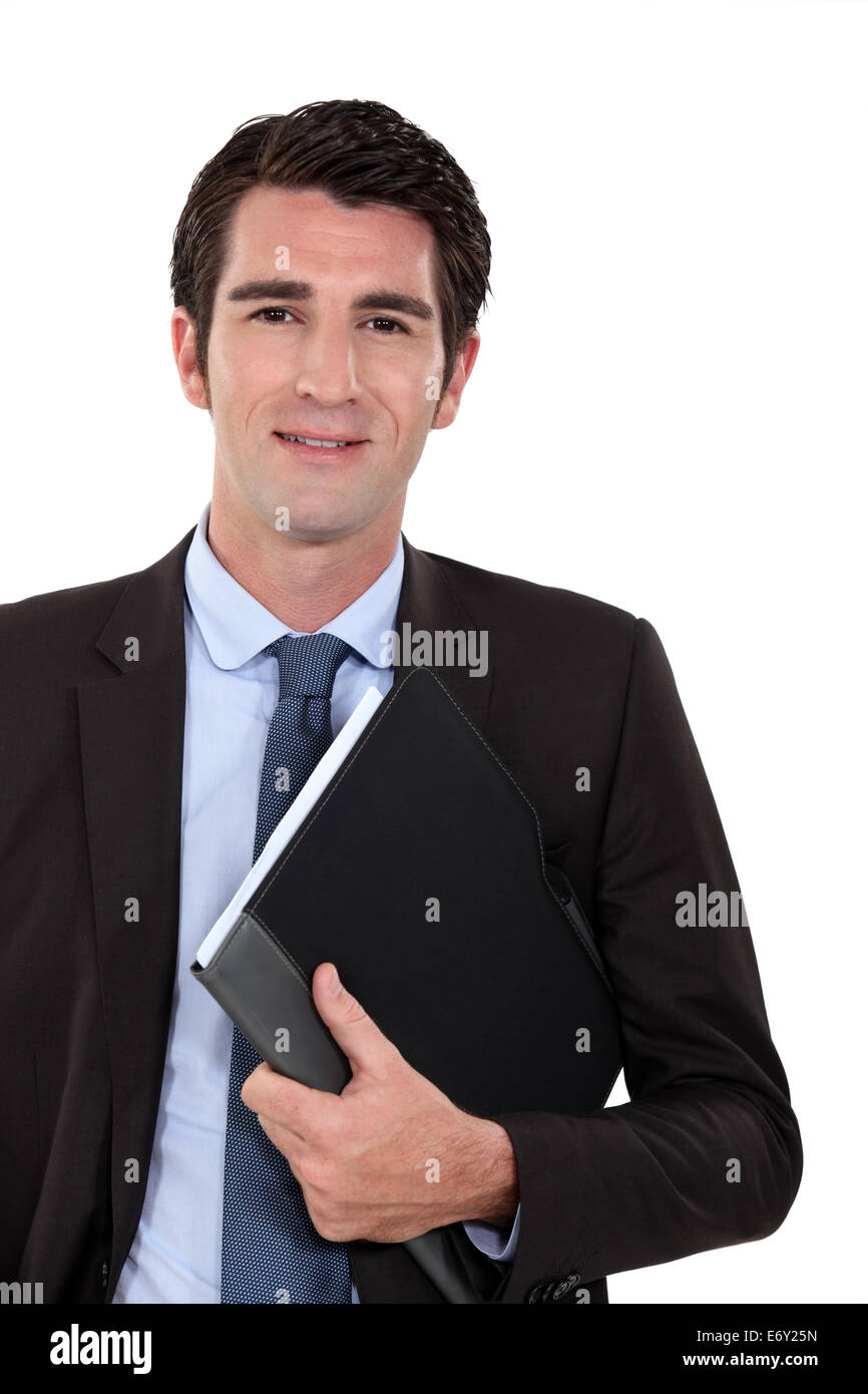 Confident businessman holding folder underarm Stock Photo - Alamy