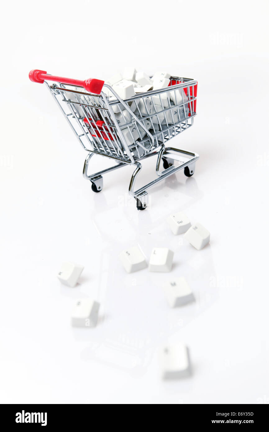 Computer Keys in the shopping cart on the white background. E-commerce ...