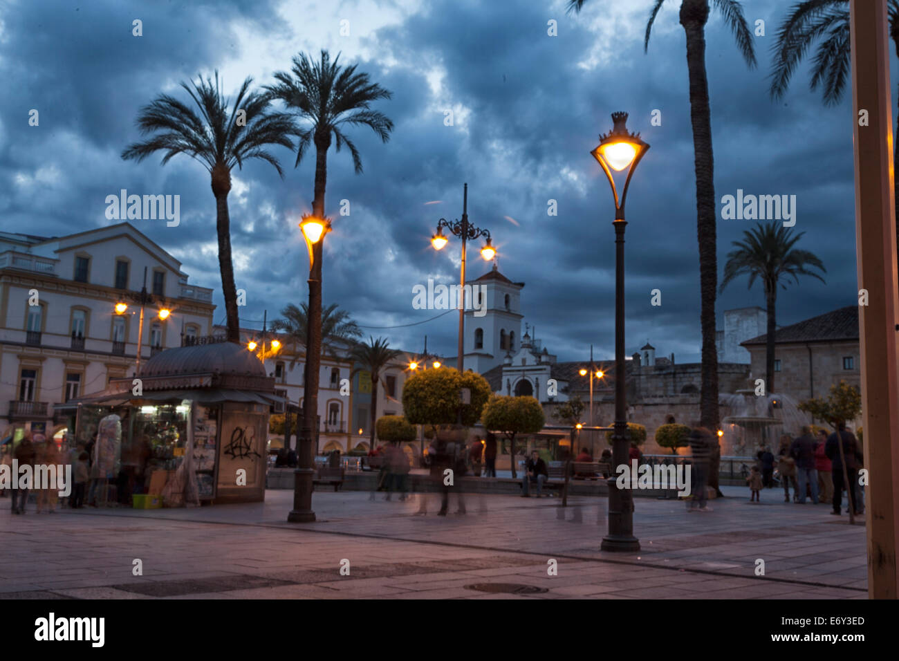 People walk and play in the Plaza Mayor of Merida Spain during the ...