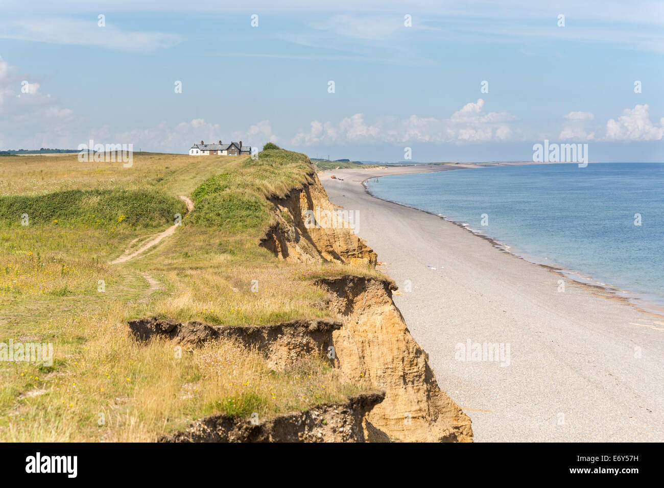 View of the Old Customs House, cliff top path, cliffs and the shoreline ...